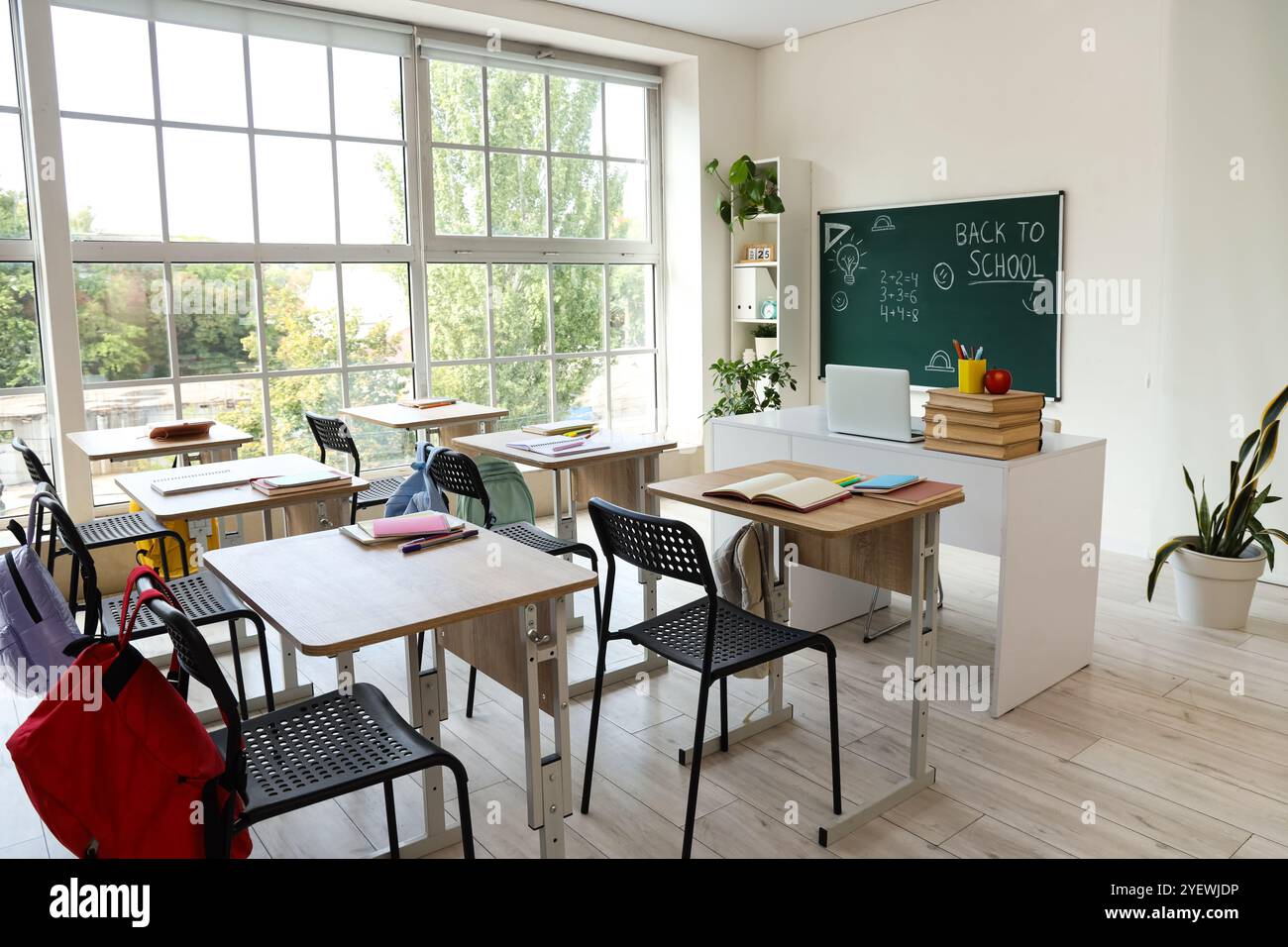 Interior of empty classroom with school desks and text BACK TO SCHOOL ...