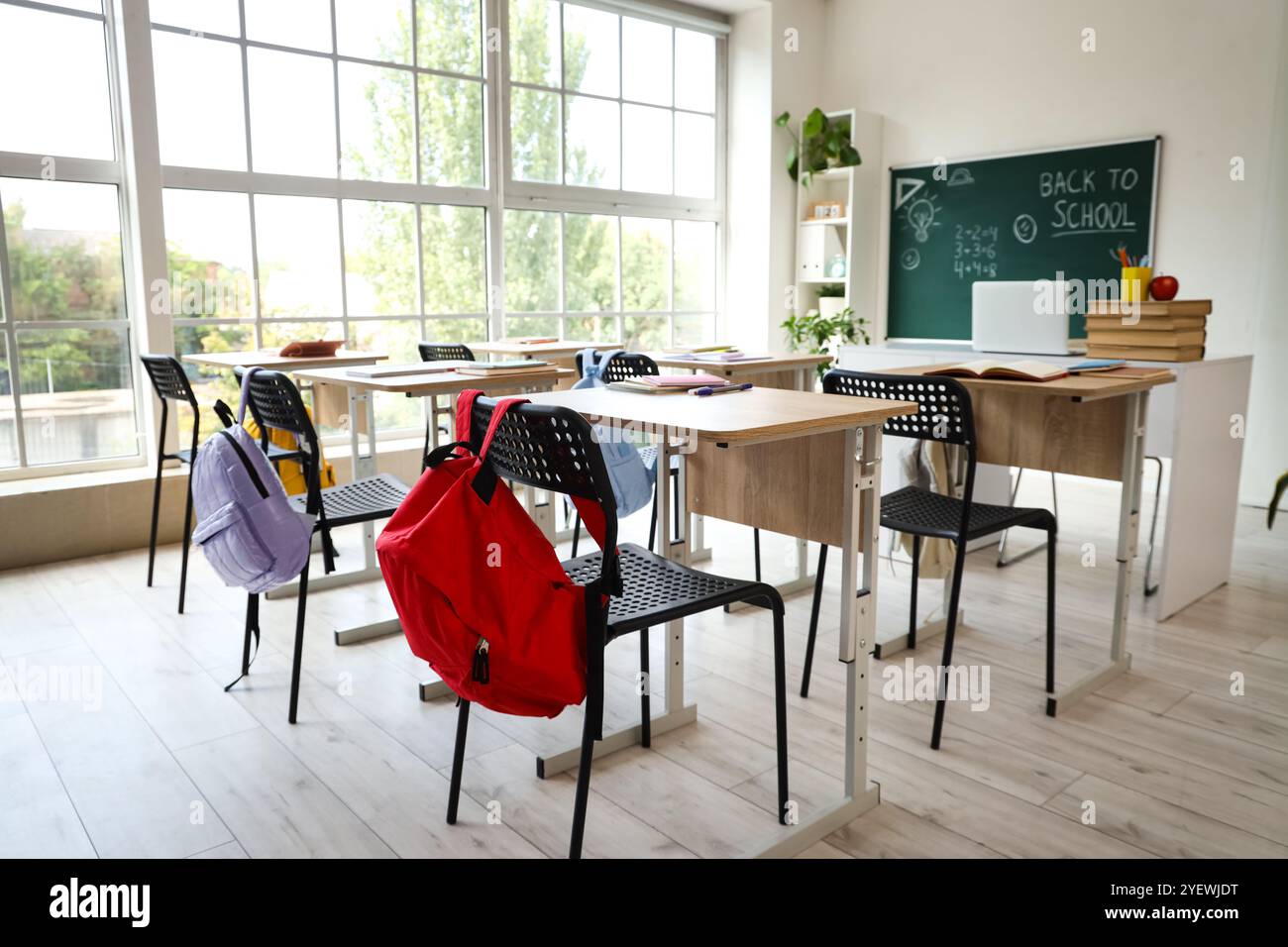 Interior of empty classroom with school desks and text BACK TO SCHOOL ...