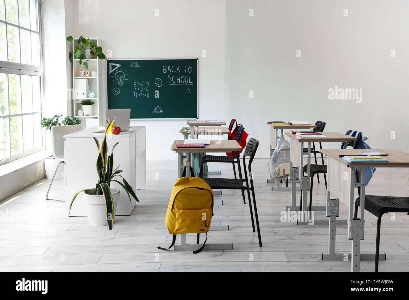Interior of empty classroom with school desks and text BACK TO SCHOOL ...