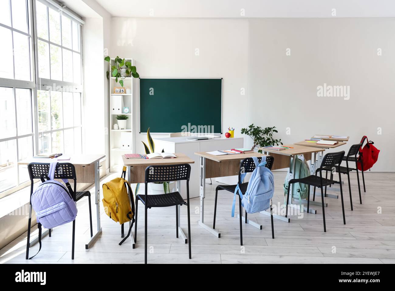 Interior of empty classroom with school desks and clean chalkboard ...