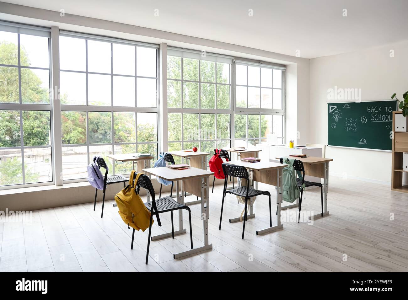 Interior of empty classroom with school desks and text BACK TO SCHOOL ...