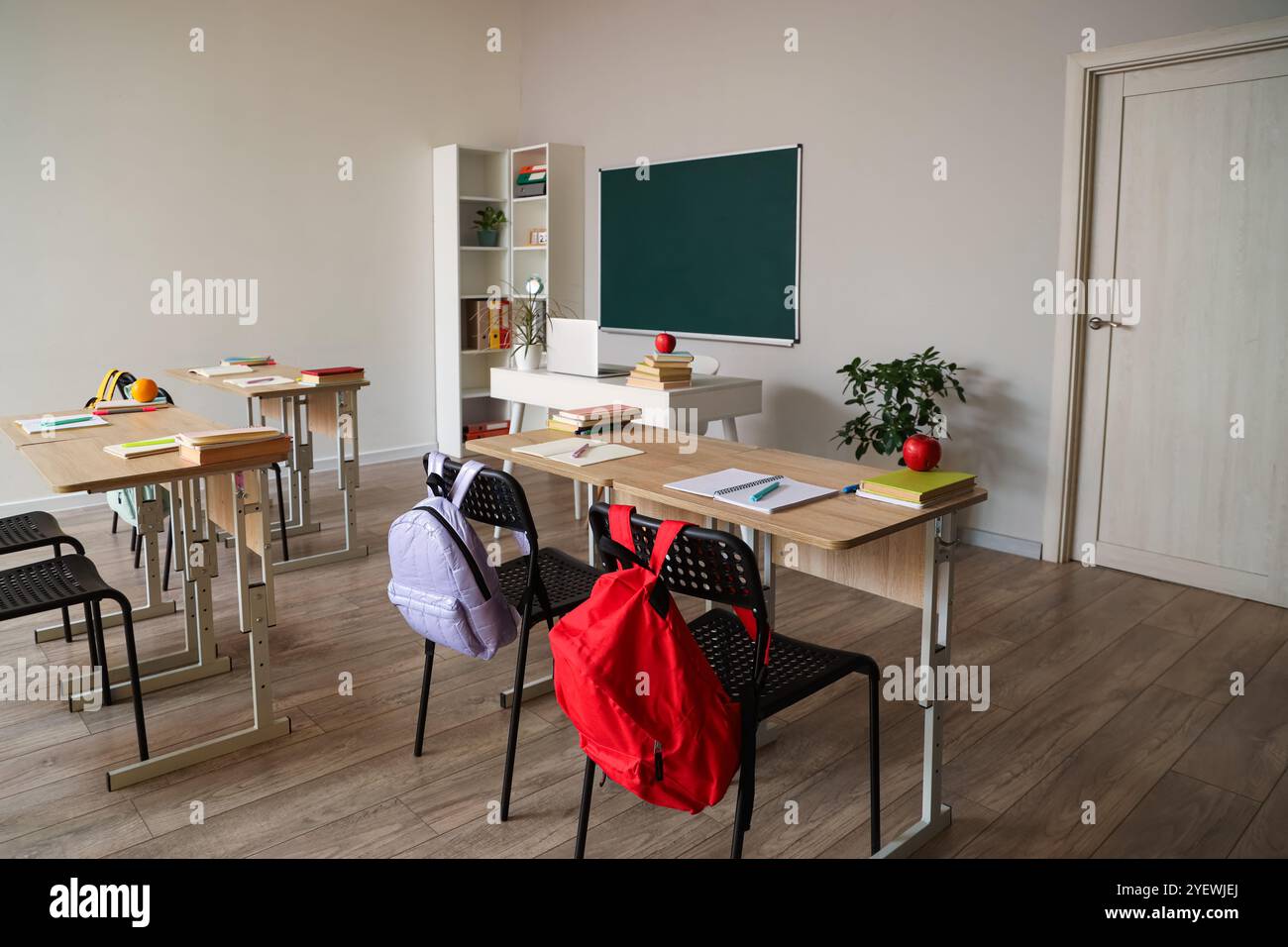 Interior of empty classroom with school desks and clean chalkboard ...