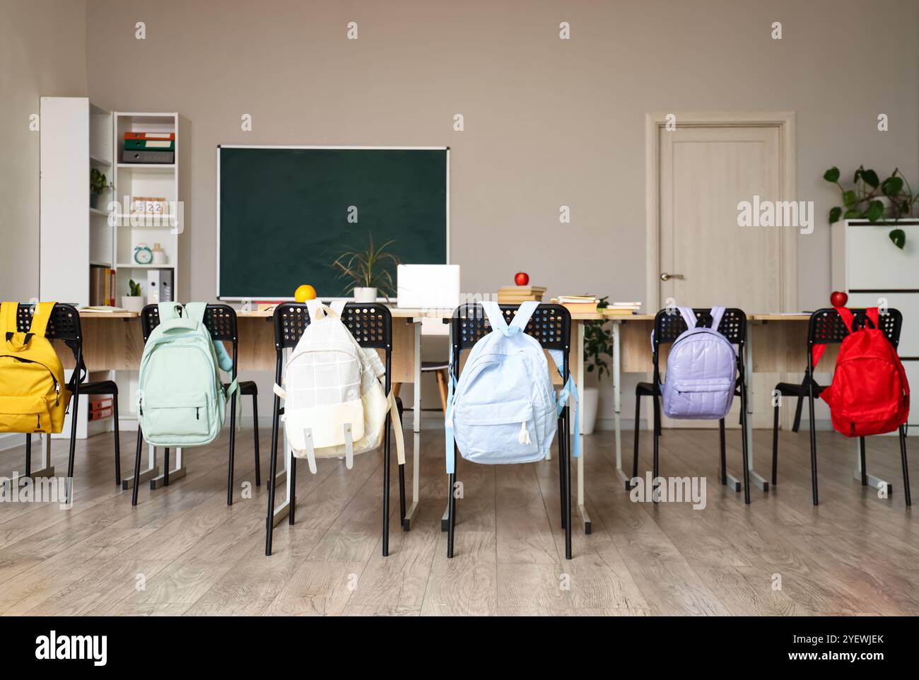 Interior of empty classroom with school desks and clean chalkboard ...