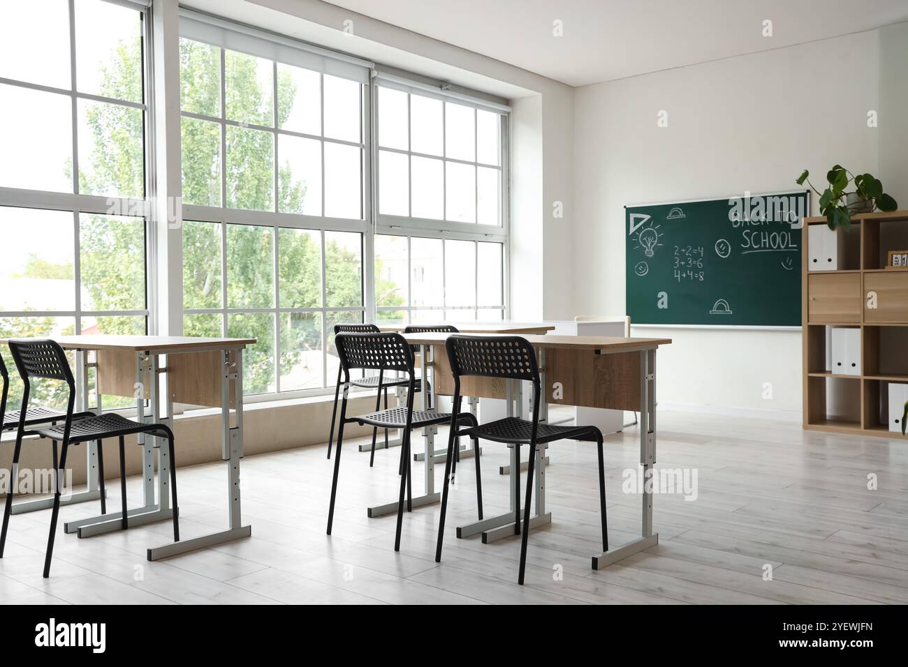 Interior of empty classroom with school desks and text BACK TO SCHOOL ...