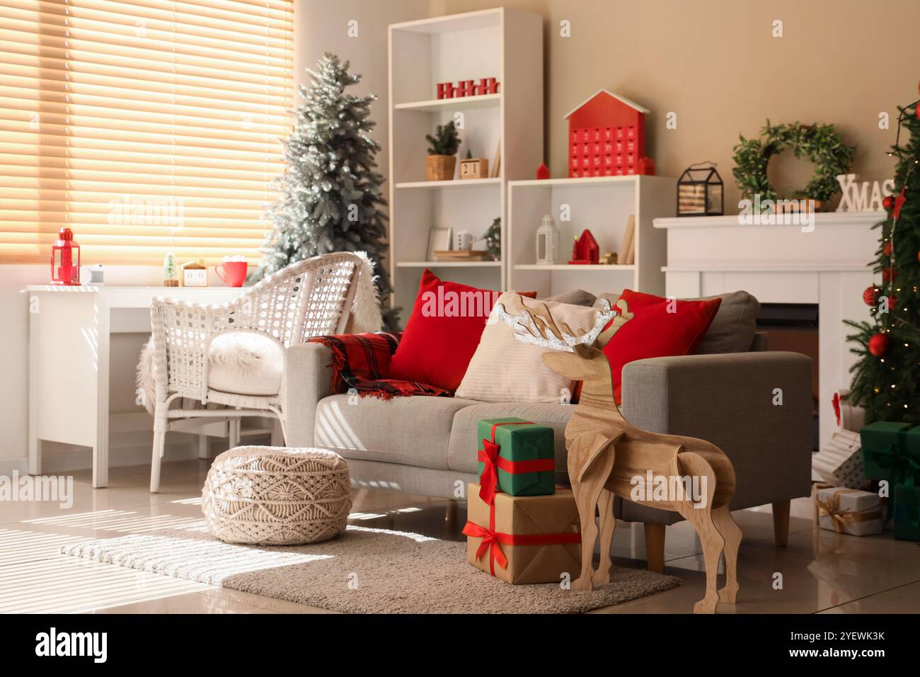 Cozy sofa and workplace with Christmas decor in interior of living room ...