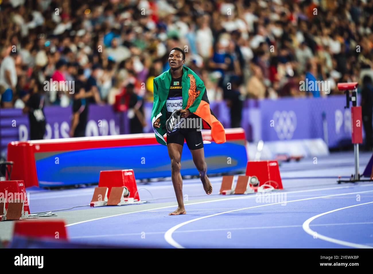 Muzala Samukonga celebrating her victory with her country's flag at the ...