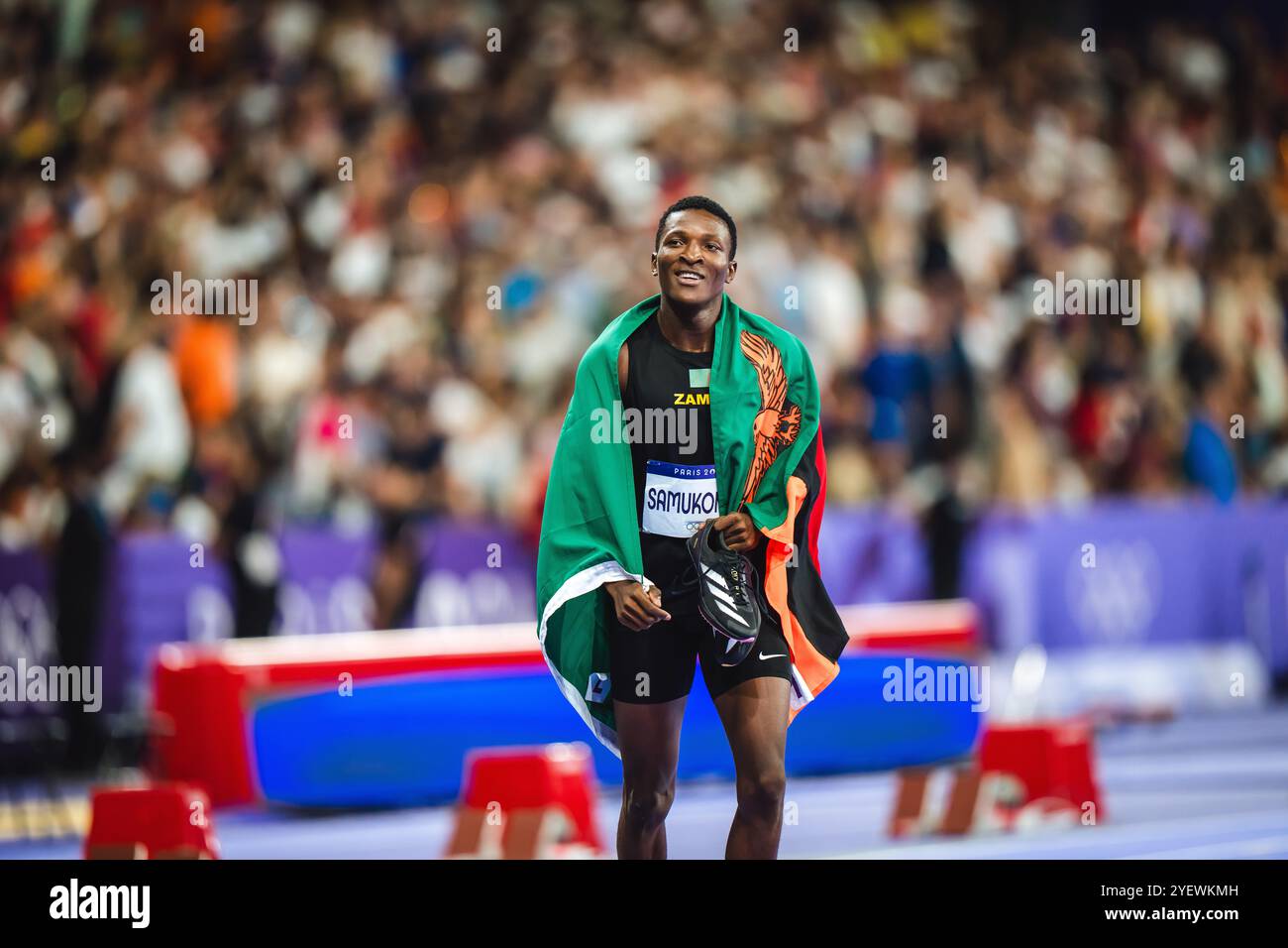 Muzala Samukonga celebrating her victory with her country's flag at the ...