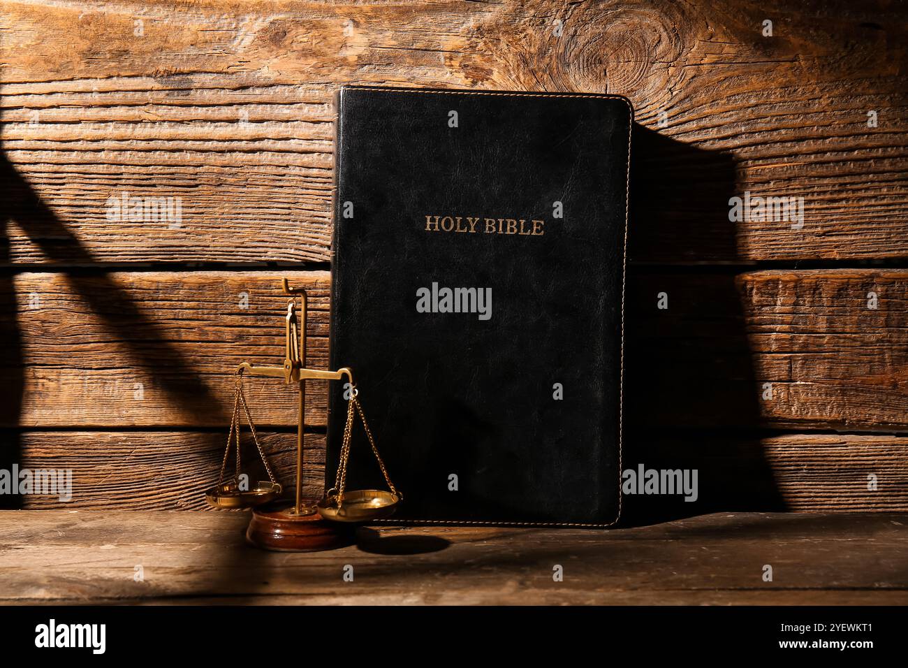Holy Bible with justice scales and shadows on wooden background Stock ...