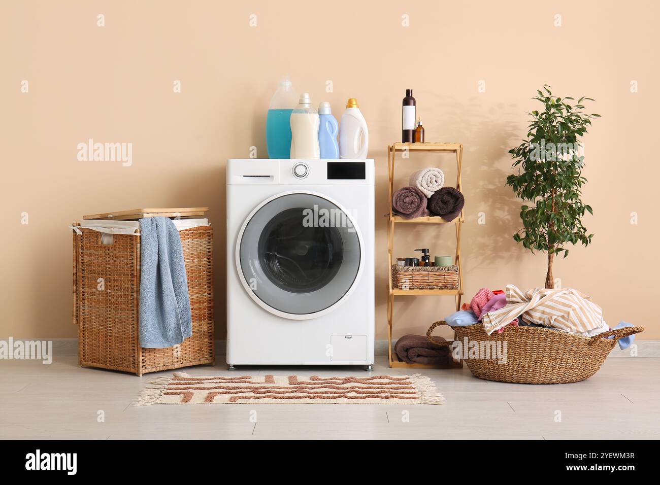 Modern washing machine, basket with laundry, shelving unit and ...