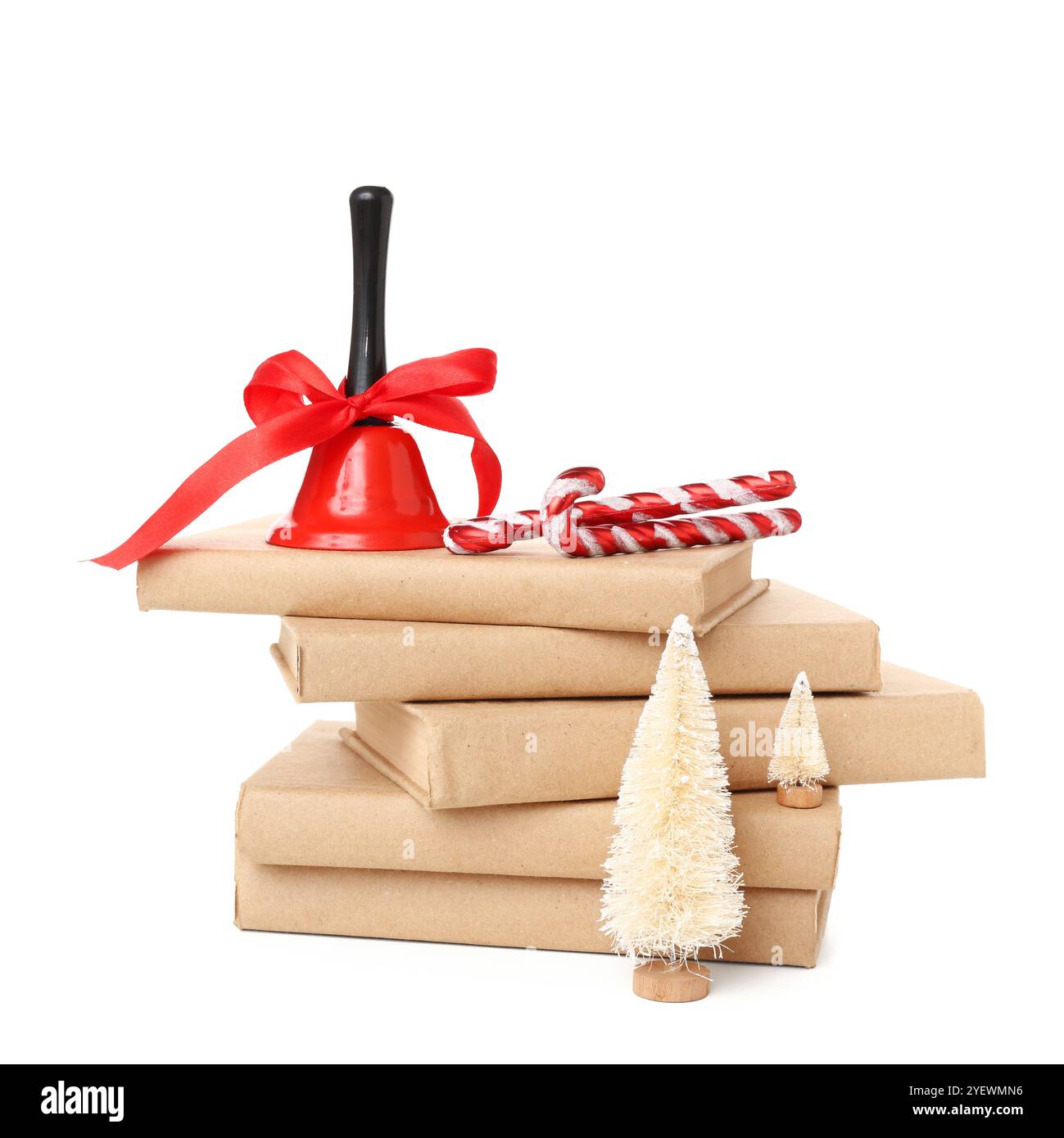 Stack of books, Christmas decorations and bell isolated on white ...