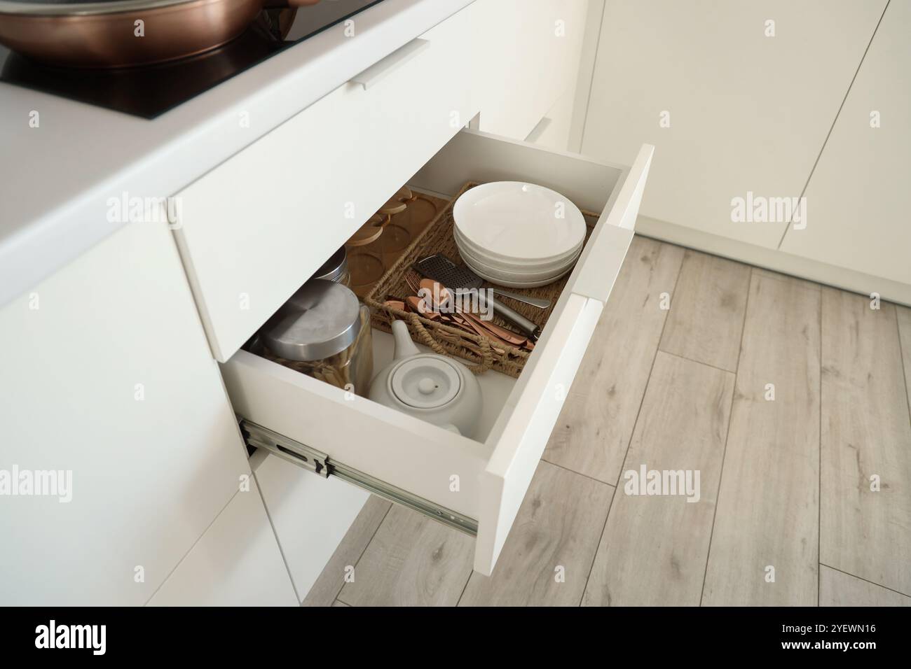 Open drawer with utensils in kitchen Stock Photo - Alamy