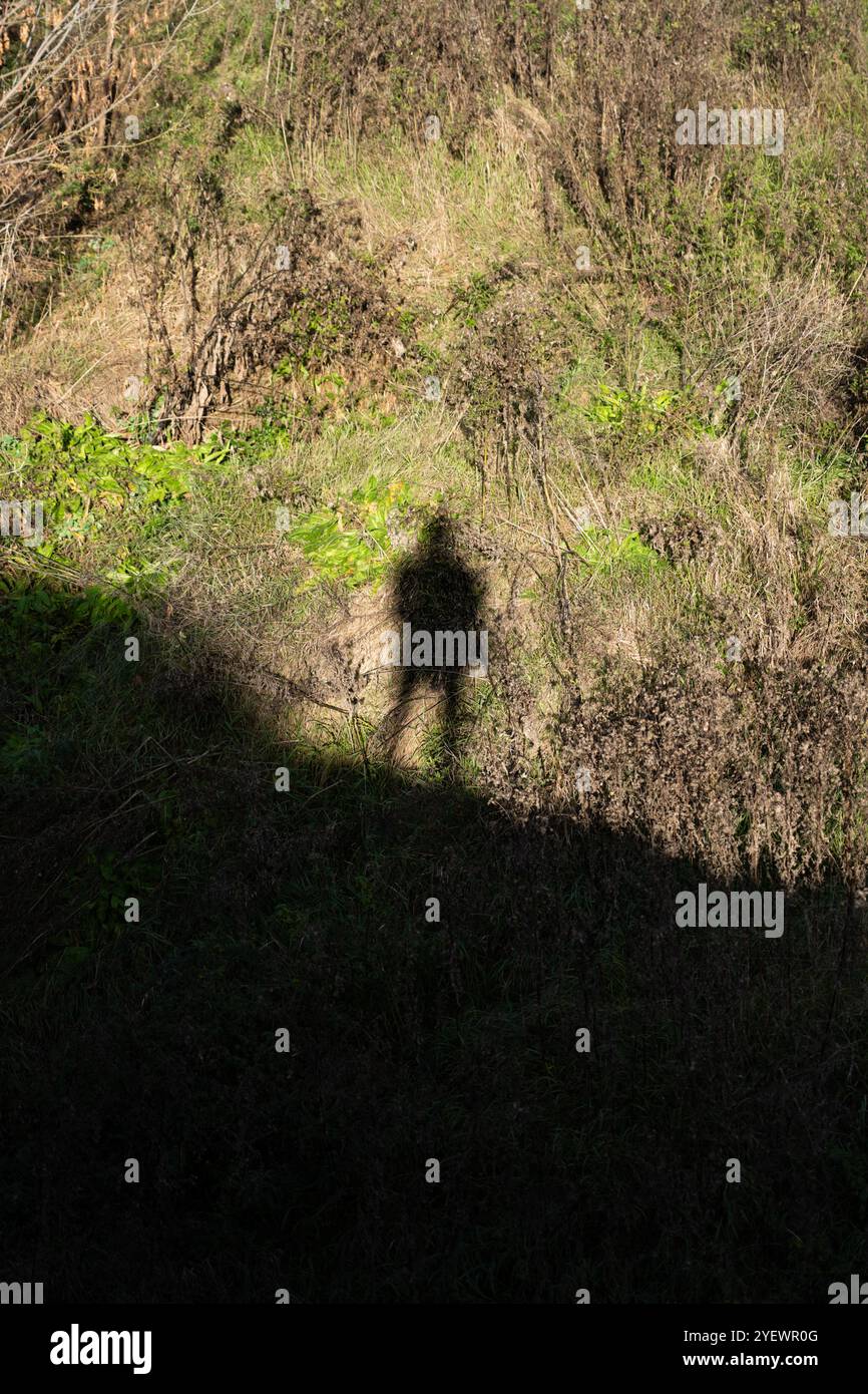 The shadow of a man in the distance looking down. The shadow of a man ...