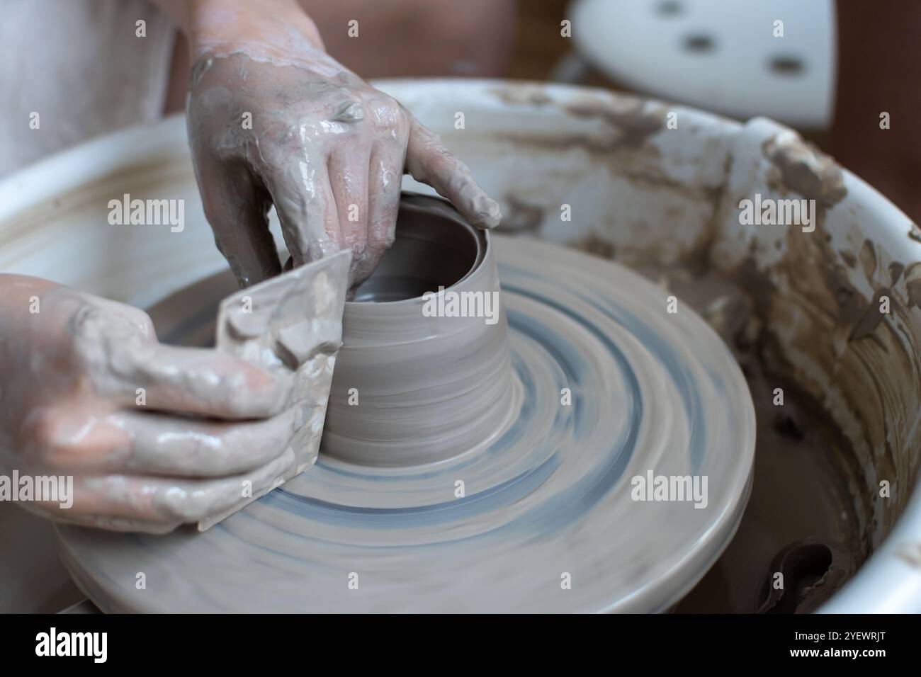 Making of mud pot on potters wheel during workshop in design modern art ...