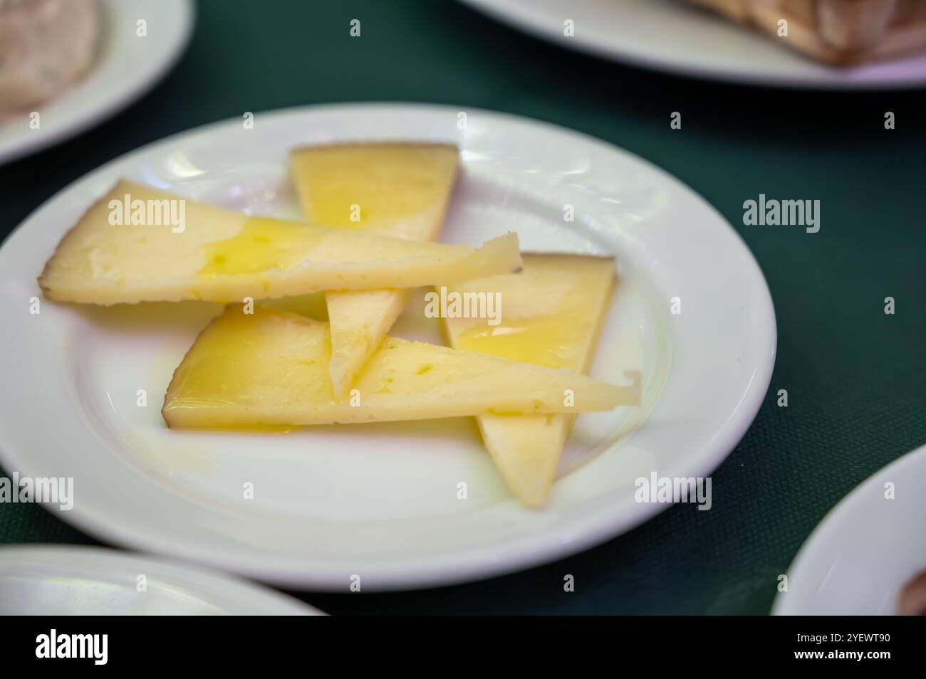 Tasting of Spanish cheeses, triangles of manchego curado cheese on ...