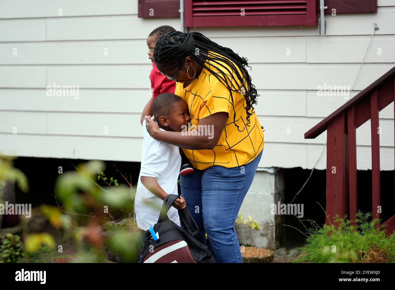 DeAnthony Nabor, 6, is hugged by family after arriving home from school ...