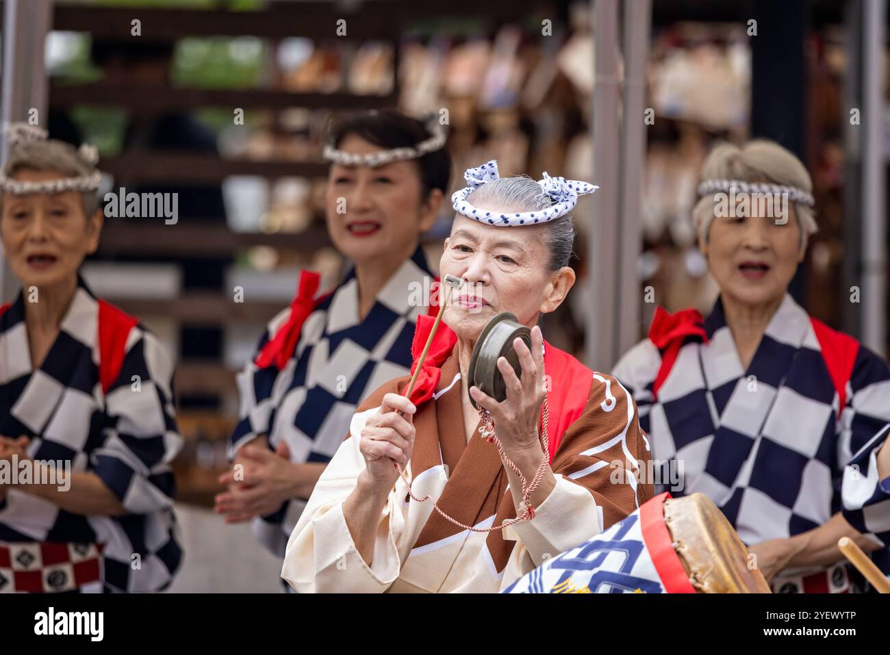 Close up of elderly Japanese woman iperfoming in traditional japanese ...