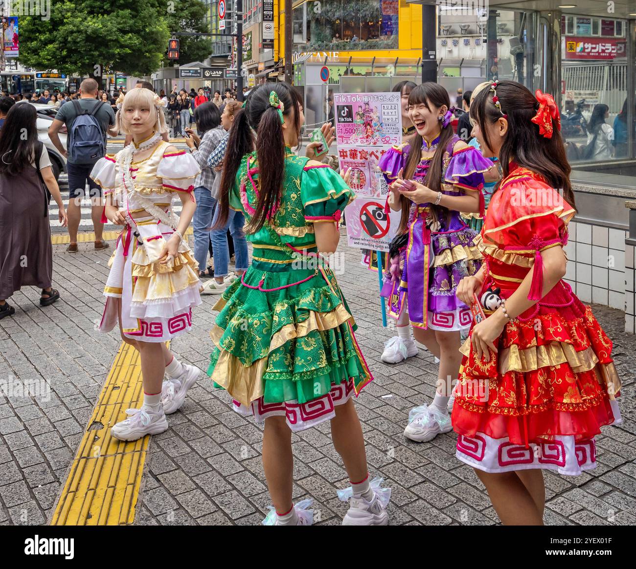 Group of young Japanese girls in brightly coloured mini skirts ...