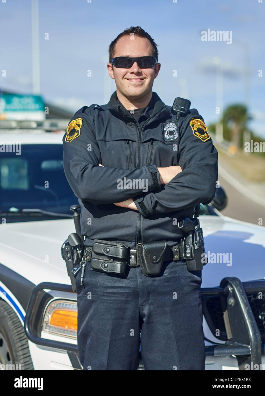 Man, arms crossed and police officer on patrol, city and uniform for ...