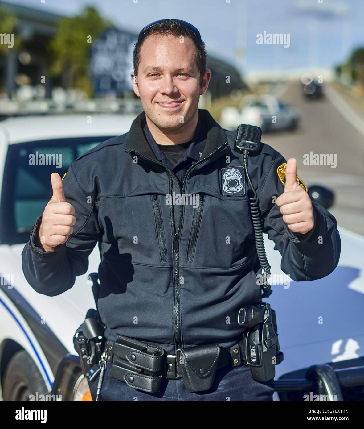 Police officer, portrait and happy with thumbs up in road for law ...