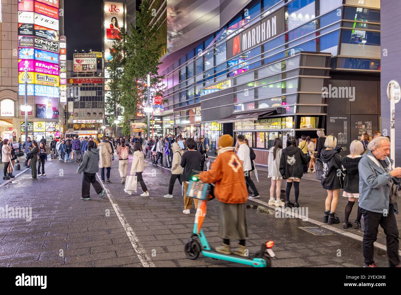 Crowded Kabukicho district at night with brightly lit buildings and ...