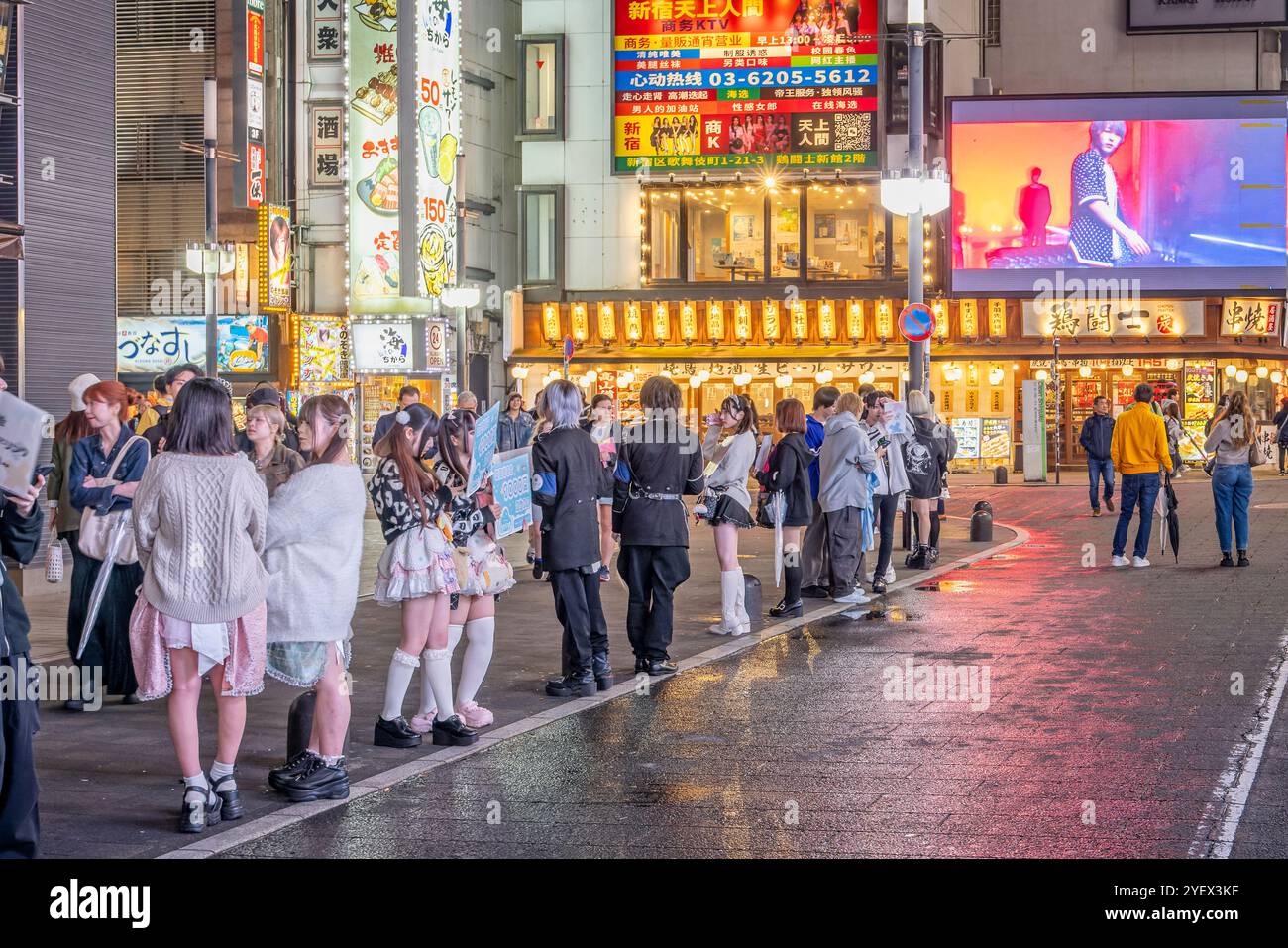 Young Japanese girls in short skirts with advertising boards in the red ...