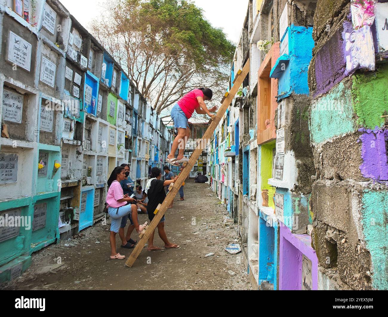 Navotas, Philippines. 01st Nov, 2024. A woman comes down from a wooden ...