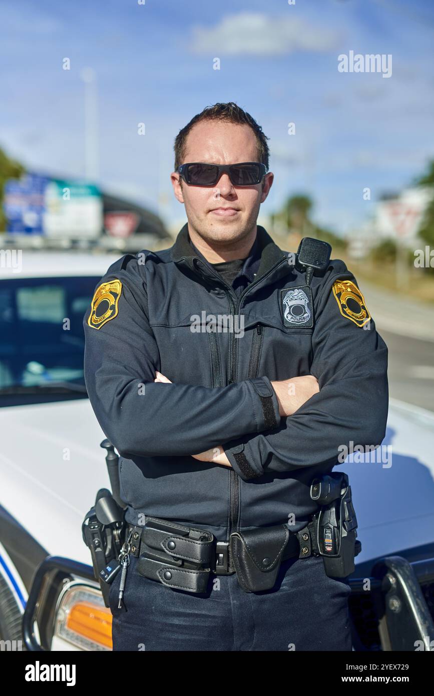 Man, arms crossed and officer of police for security, outdoor and ...