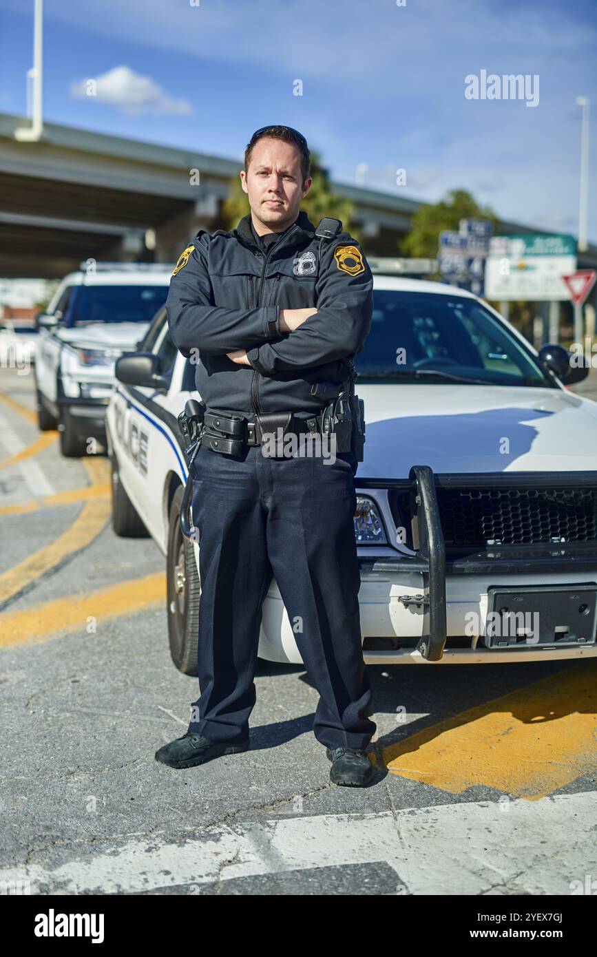 Man, portrait and police officer with arms crossed, outdoor and uniform ...