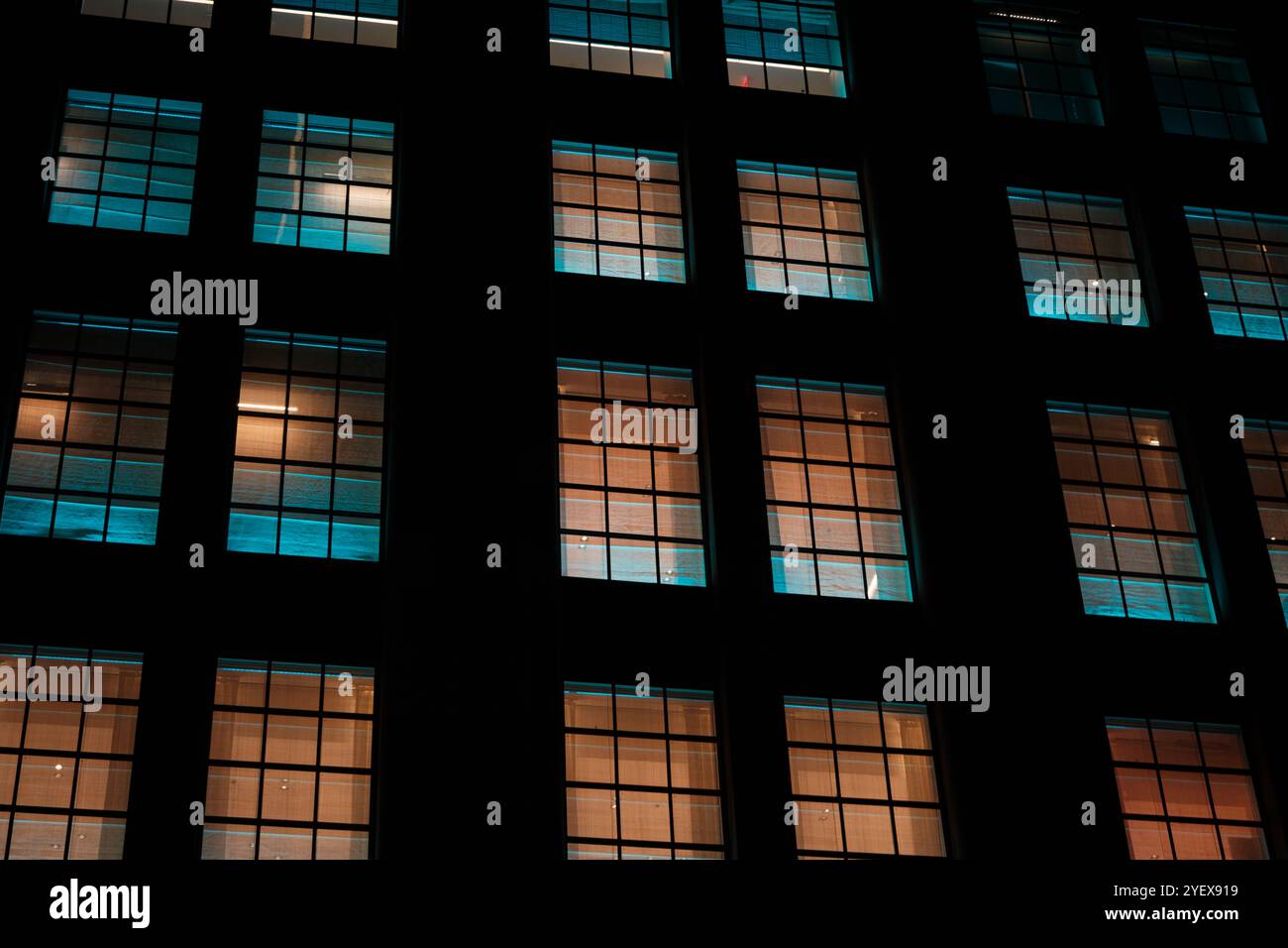 The image shows an illuminated building facade at night in Midtown ...