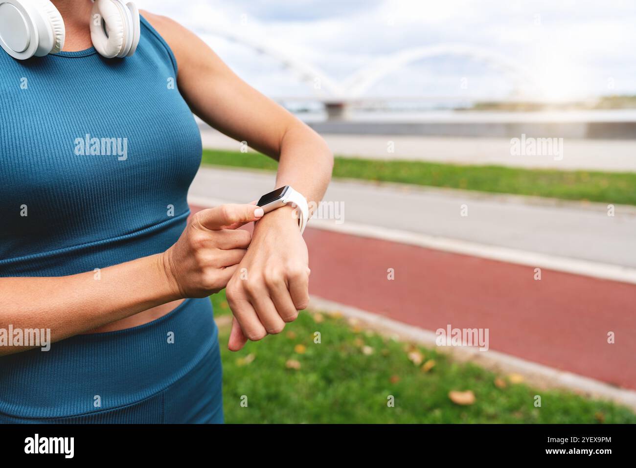 Female runner’s wrist with smartwatch tracking health metrics on ...
