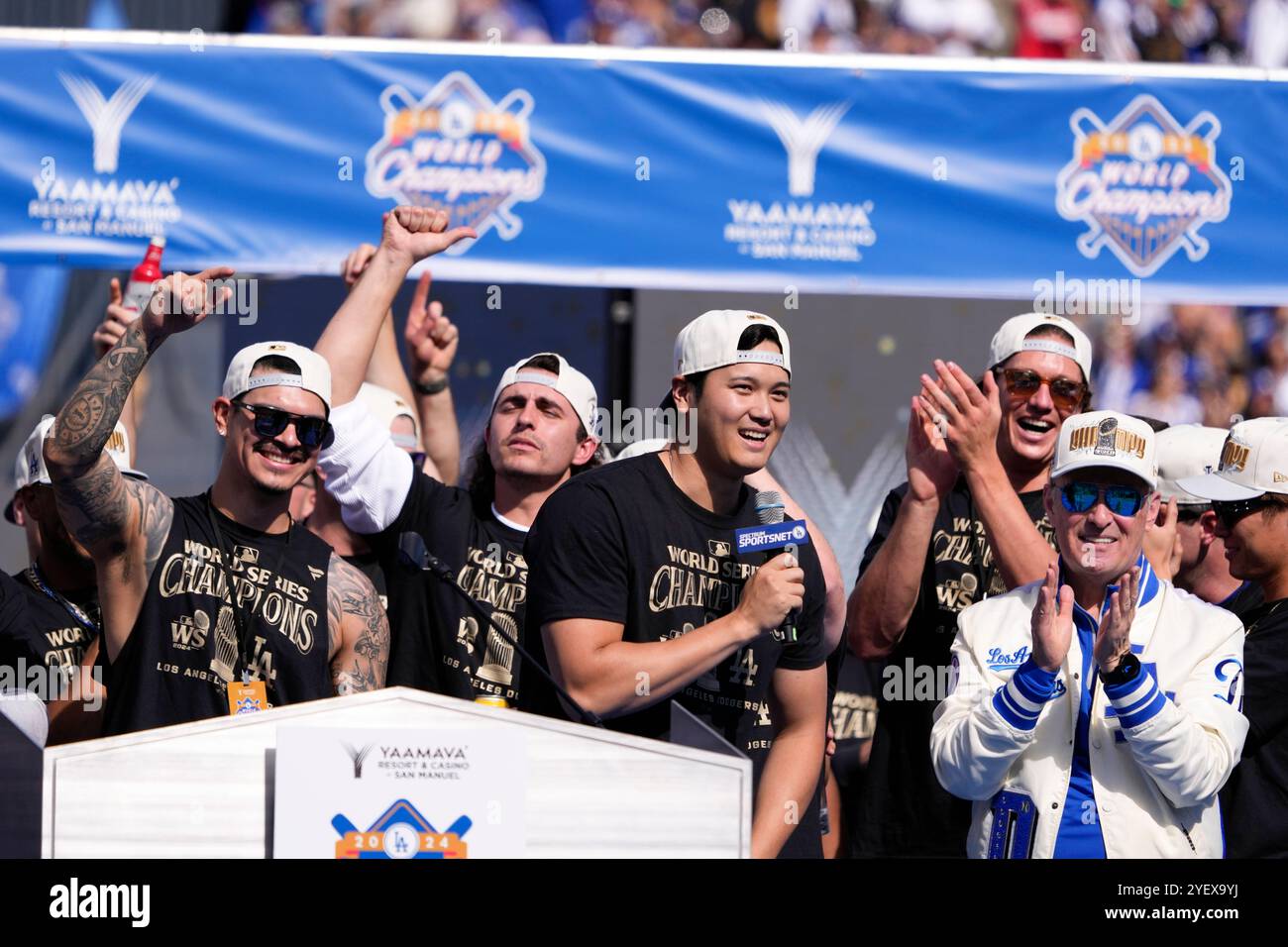 Los Angeles Dodgers' Shohei Ohtani smiles as he addresses the crowd ...