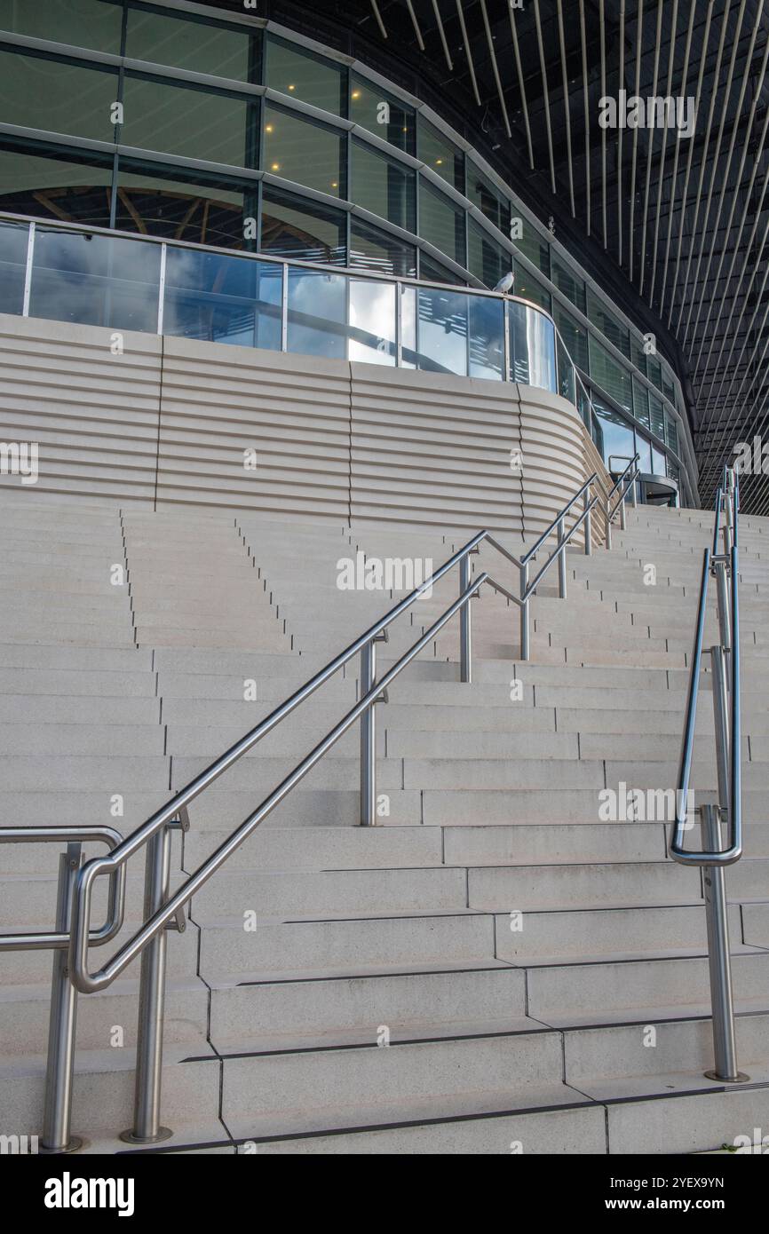 abstract architectural image of stone steps and chrome railings under ...