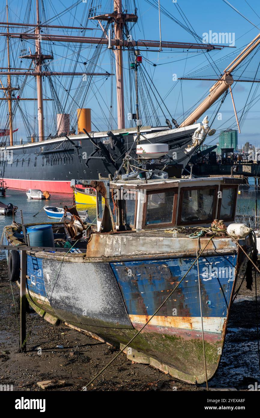 HMS Warrior alongside at Portsmouth historic dockyard with an old ...