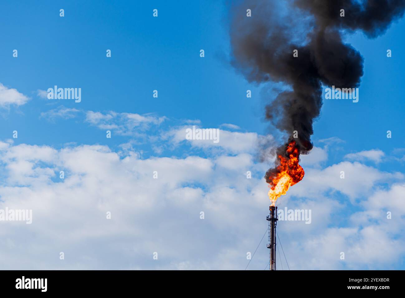 Refinery flare stack with large flare and lots of black smoke Stock ...