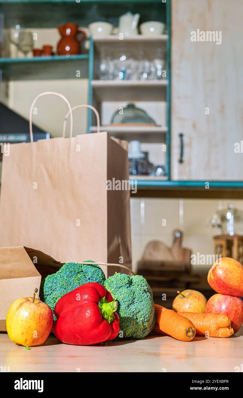 Paper bags on a kitchen counter with fresh vegetables coming out of ...