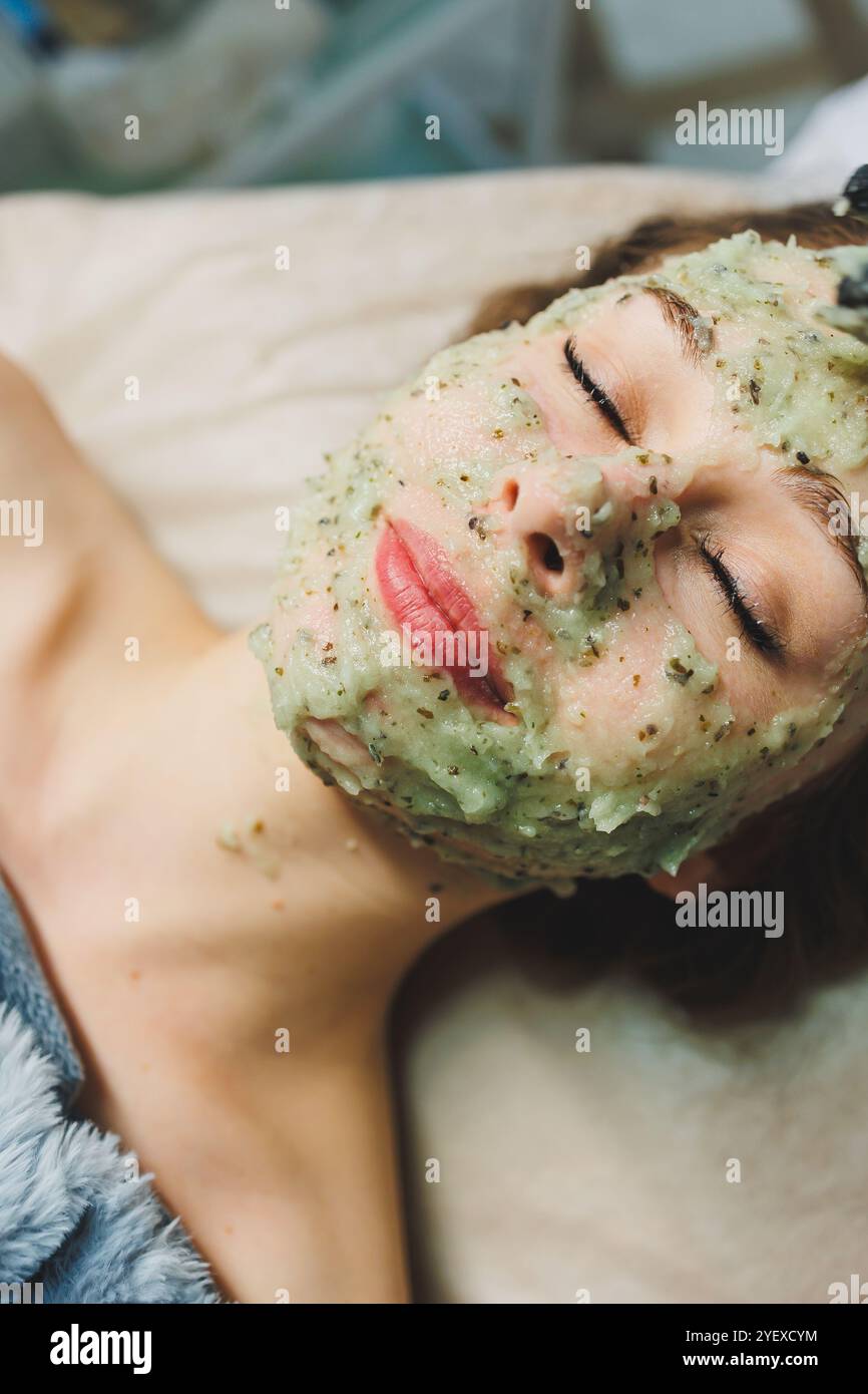 Facial skin care. A woman's face with an organic mask to moisturize the ...