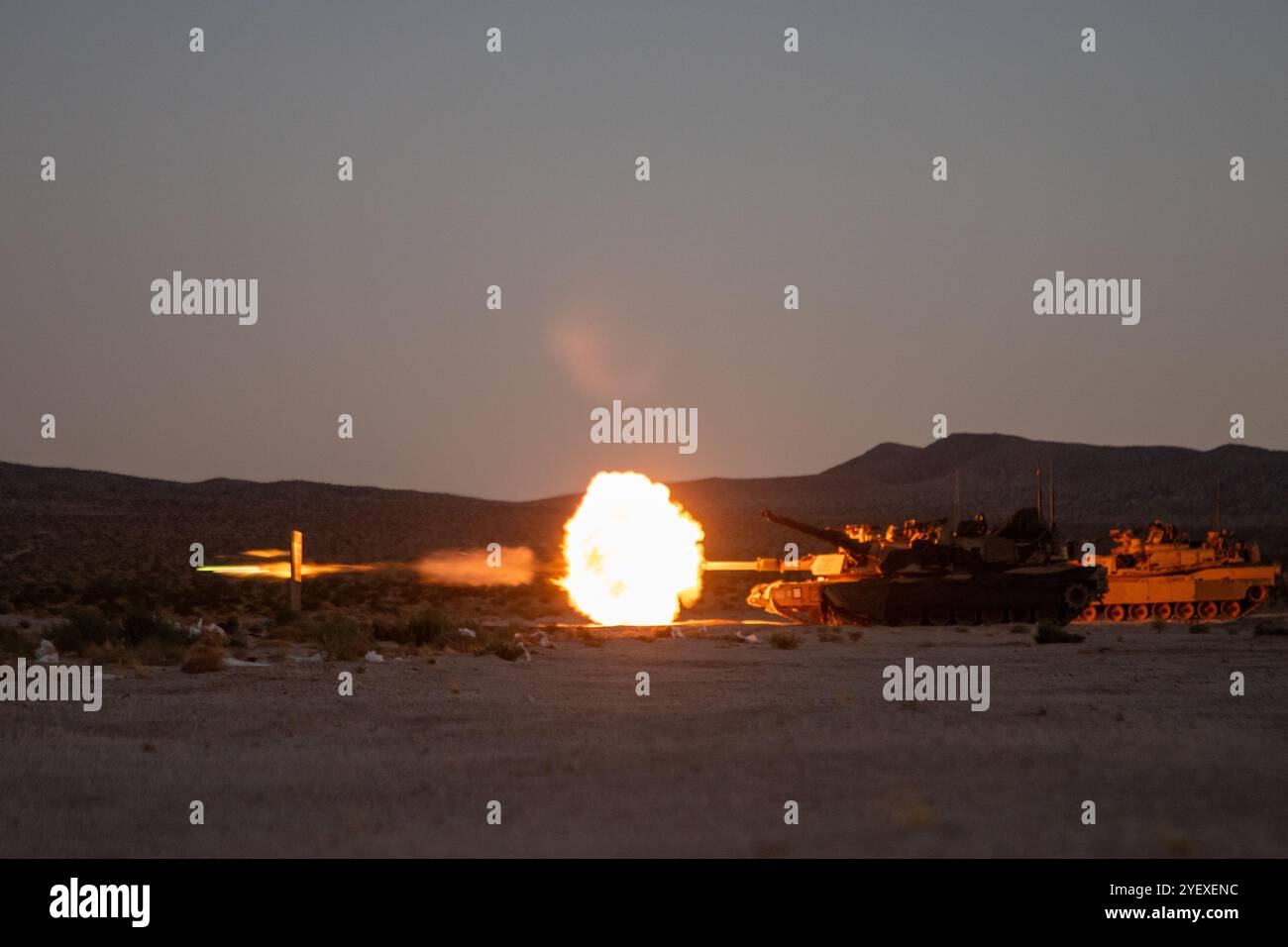 An M1A2 Abrams tank expends a anti tank round during live fire training ...