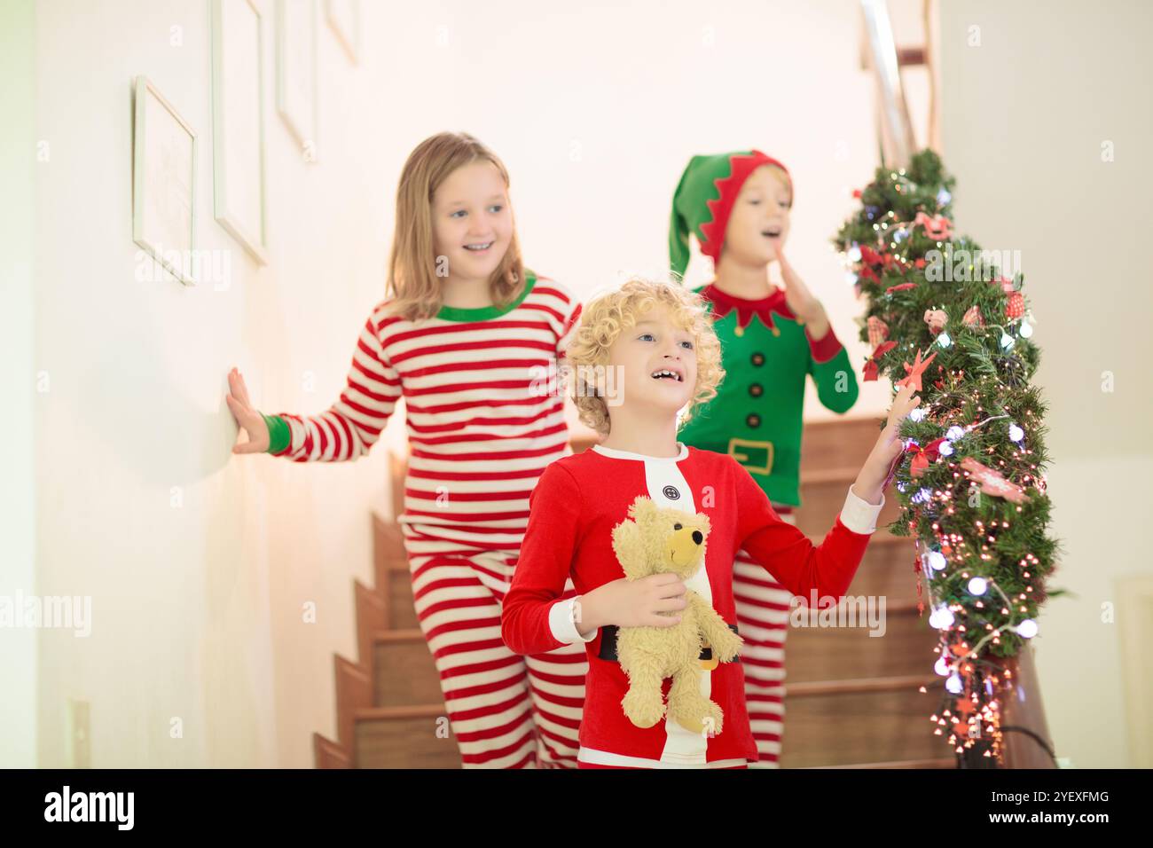 Kids running stairs on Christmas morning. Children in pajamas run ...