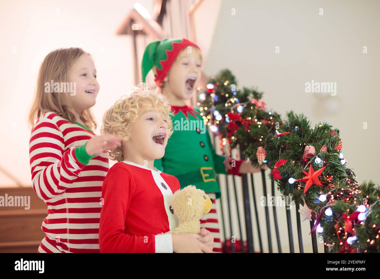 Kids running stairs on Christmas morning. Children in pajamas run ...
