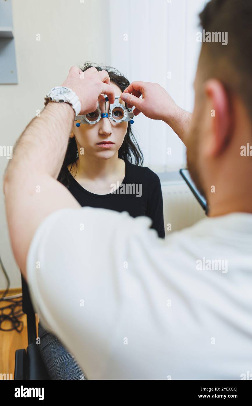 Eye examination of a young woman at an ophthalmologist's appointment ...