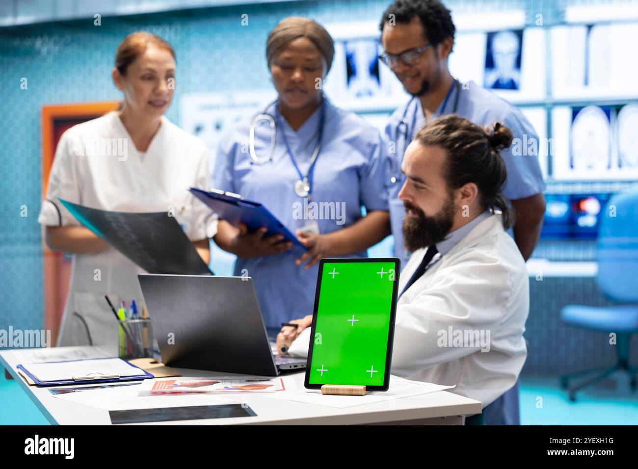 Diverse team of specialists examining radiography test scans with ...