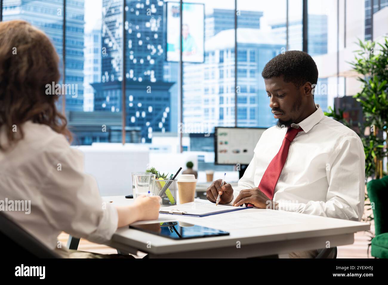 Recruiter in office meeting with african american man after finding ...