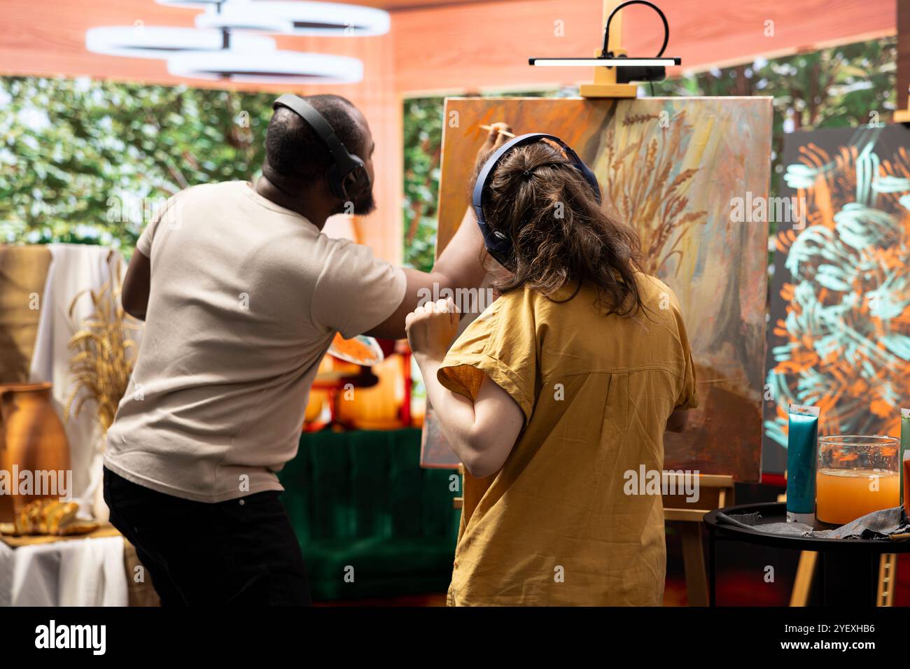 In a modern studio, diverse artists using oil paints to create a ...