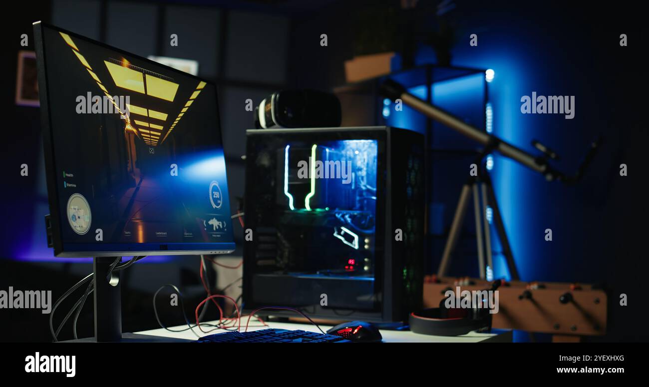 Panning shot of empty neon lit living room with RGB lit computer on ...