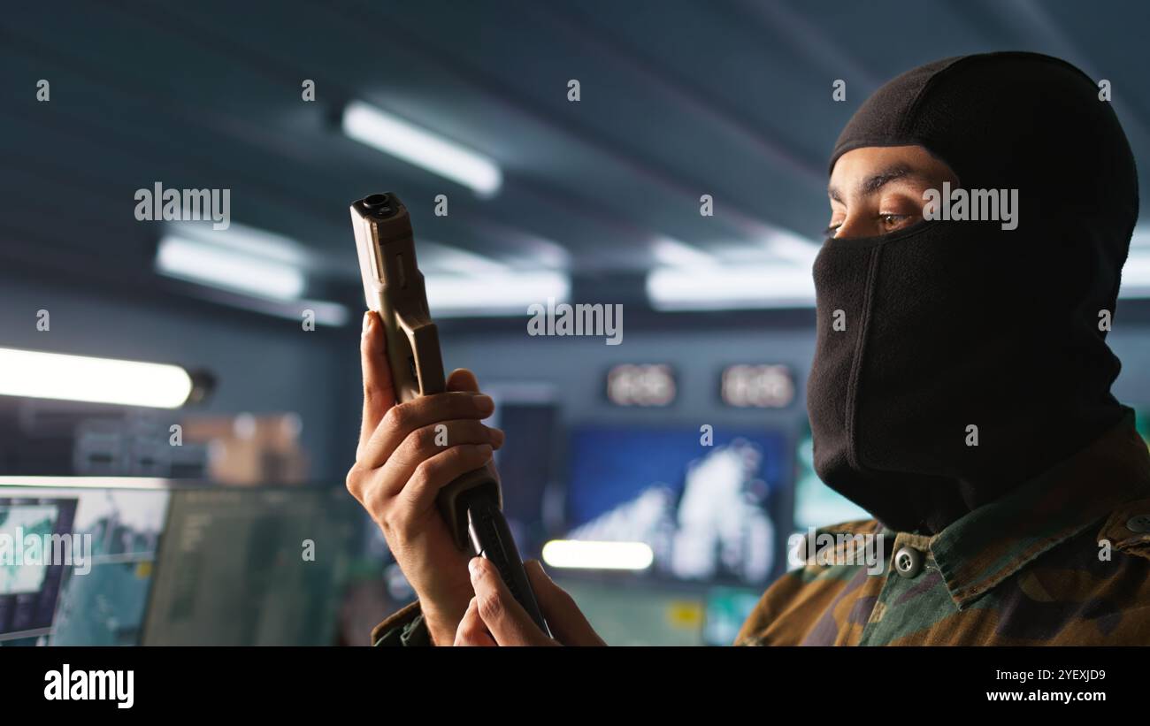 Portrait of terrorist loading gun, attacking enemy command center ...