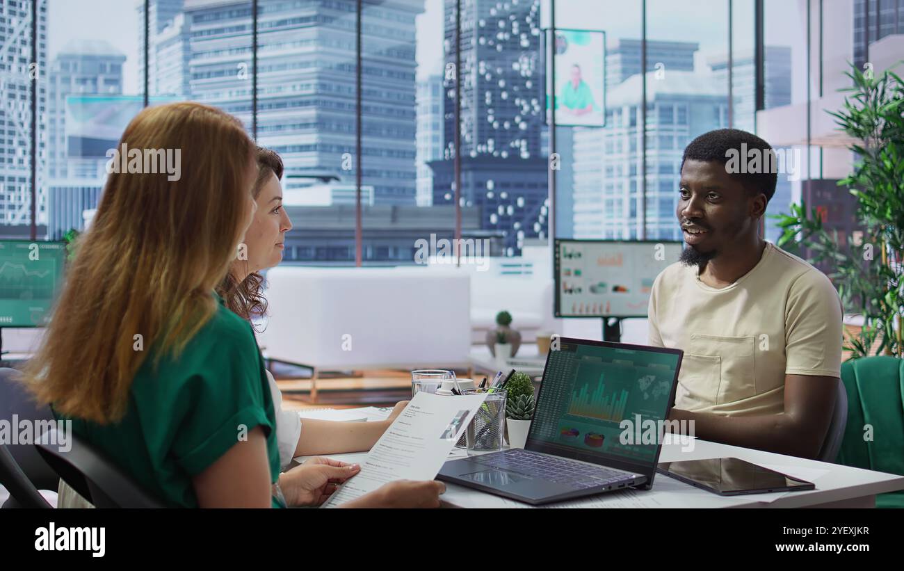 Professional businesswoman reviews the resume of a job candidate during ...