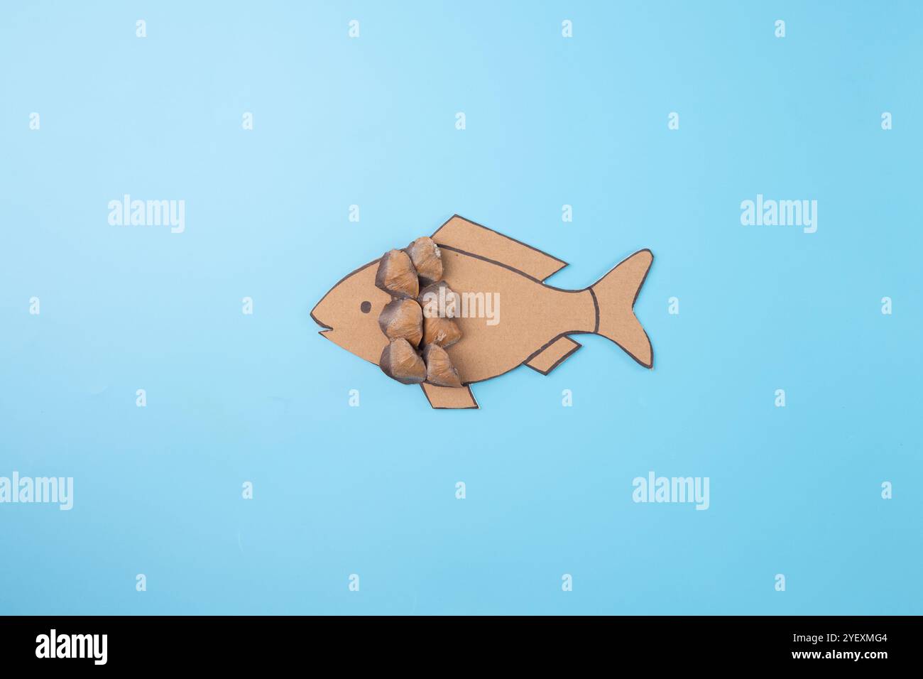 a paper cut out of a fish on a blue surface, conceptual art, step in ...