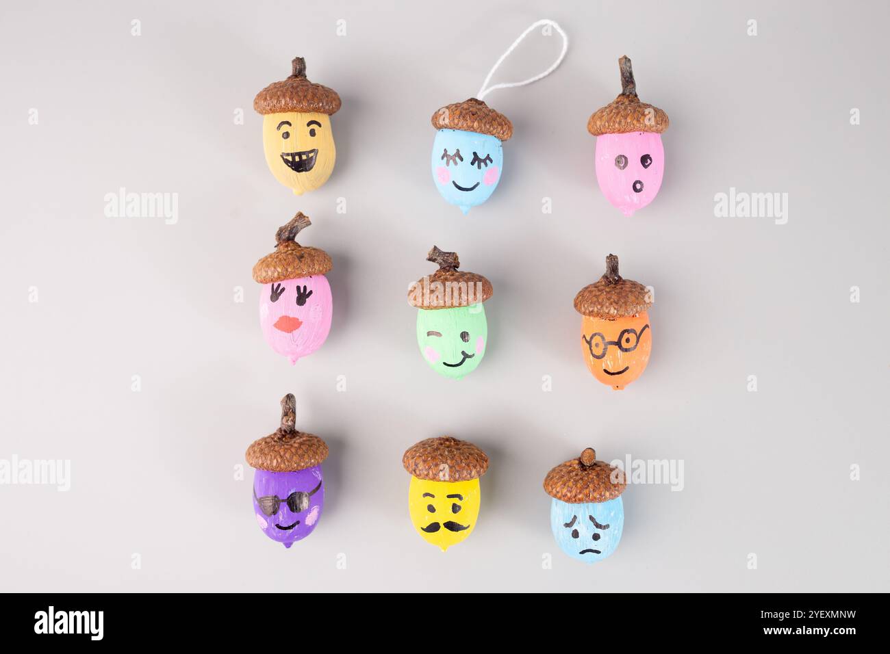 Colorful acorns with emoji faces on grey background. Autumn DIY craft ...