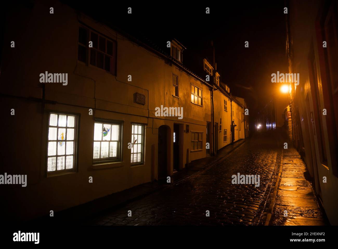 Light pours from cottage windows along Henrietta Street at night ...