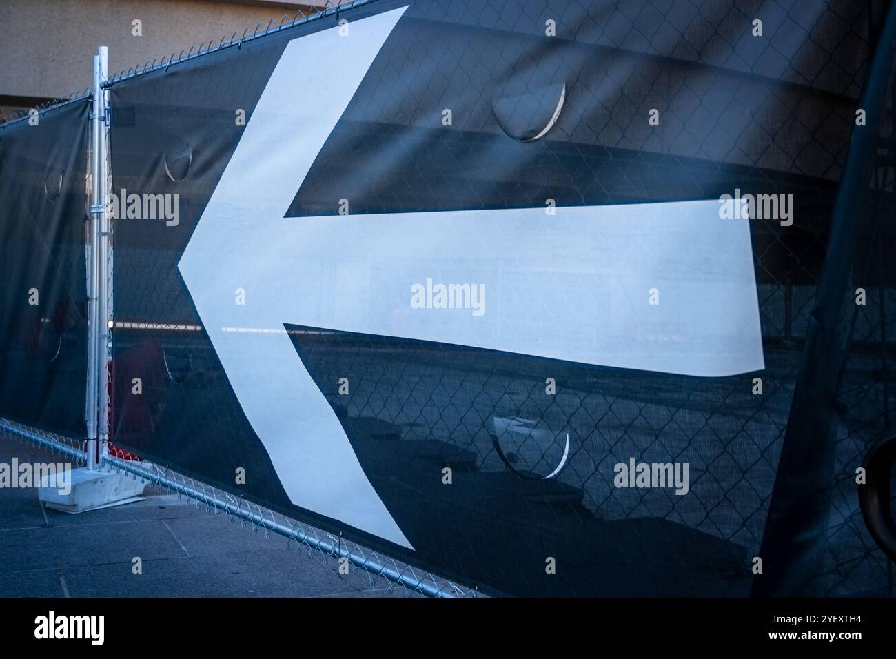 Large canvas sign with a bold white arrow on a black background ...